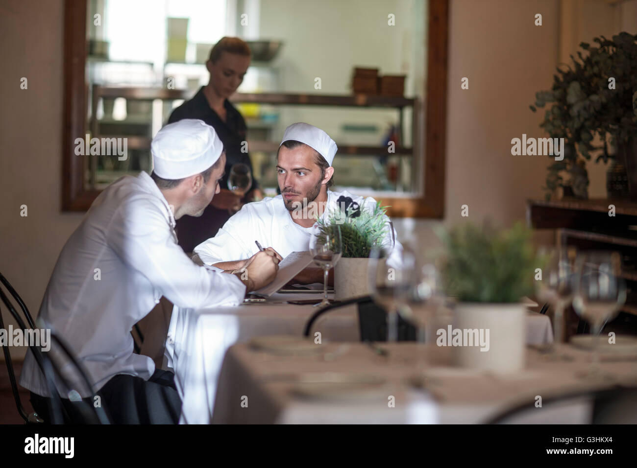 Chefs in discussion at break time Stock Photo - Alamy