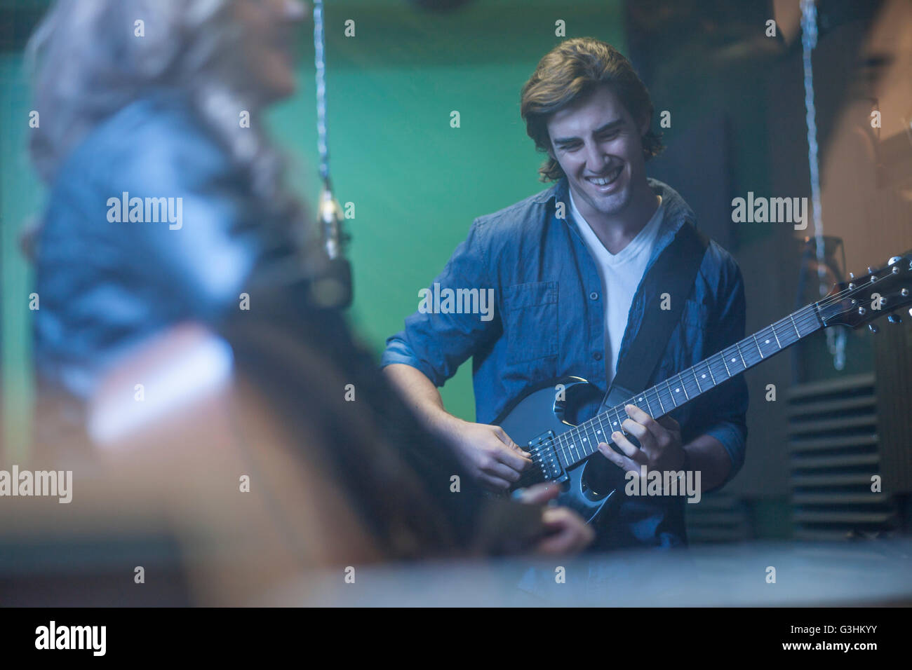 Two musicians in recording studio, playing guitar Stock Photo - Alamy