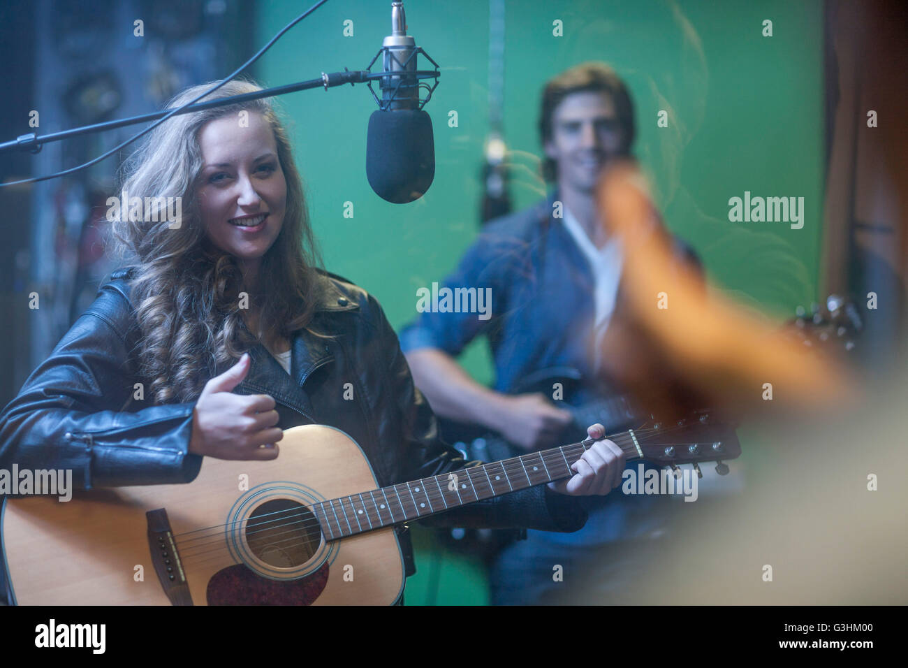 Two musicians in recording studio, playing guitar Stock Photo - Alamy