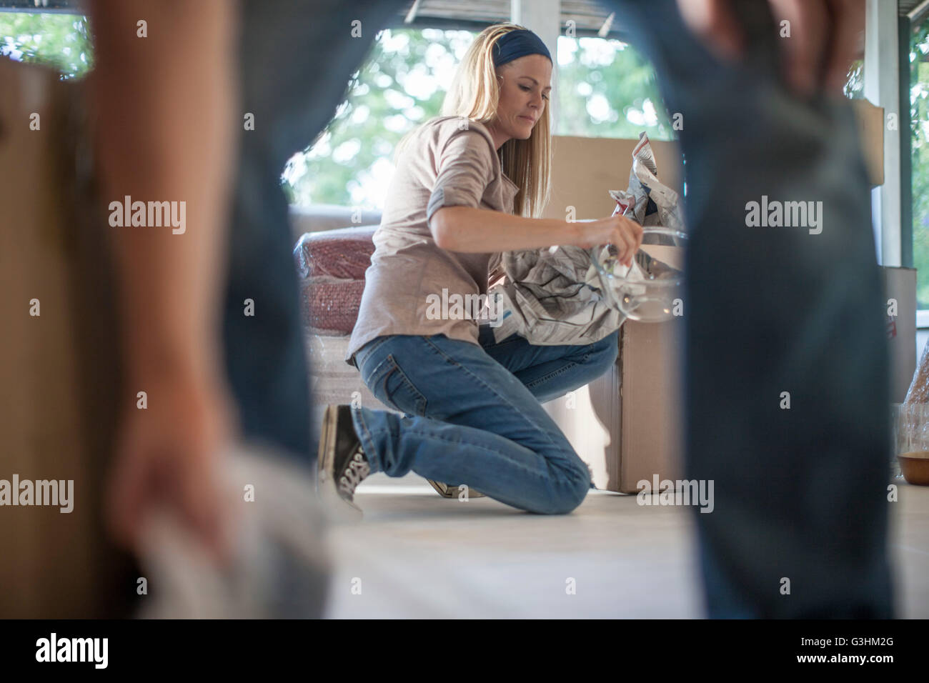 Woman unpacking glassware box hi-res stock photography and images - Alamy