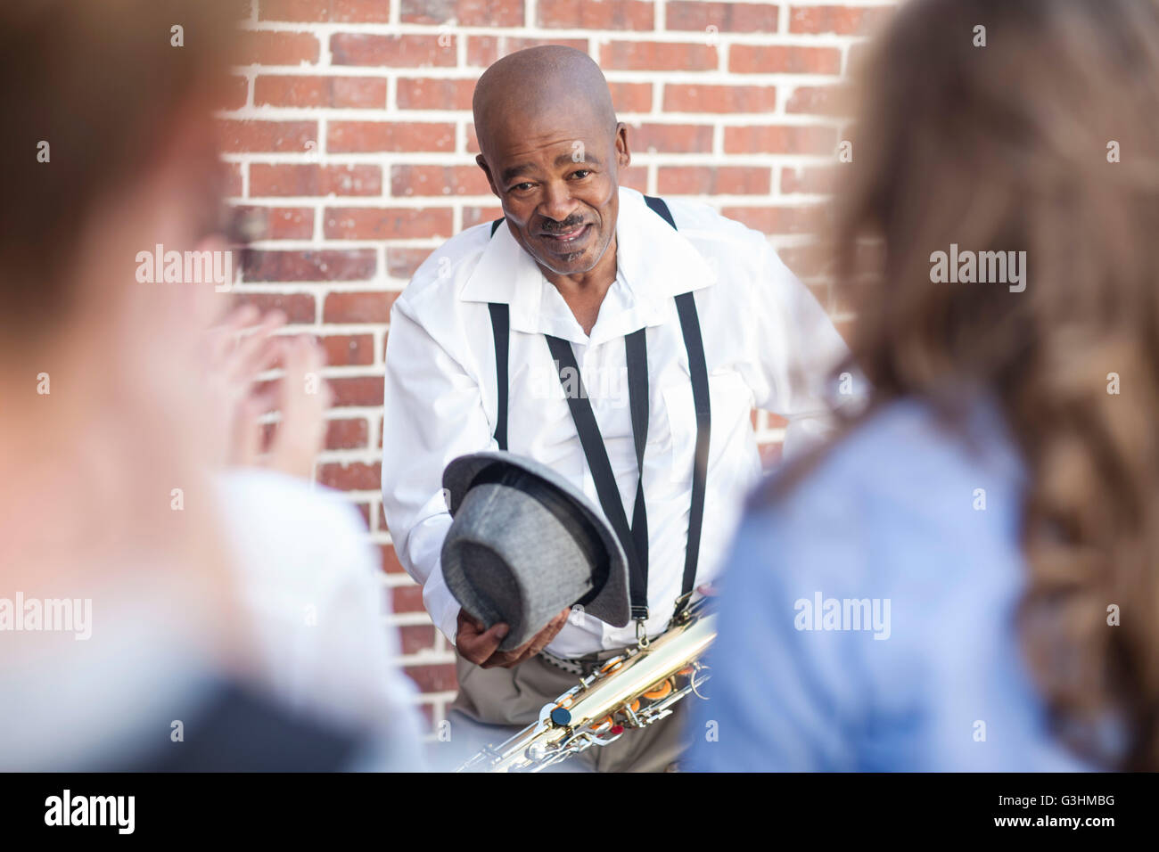 Street musician bowing to crowd Stock Photo - Alamy