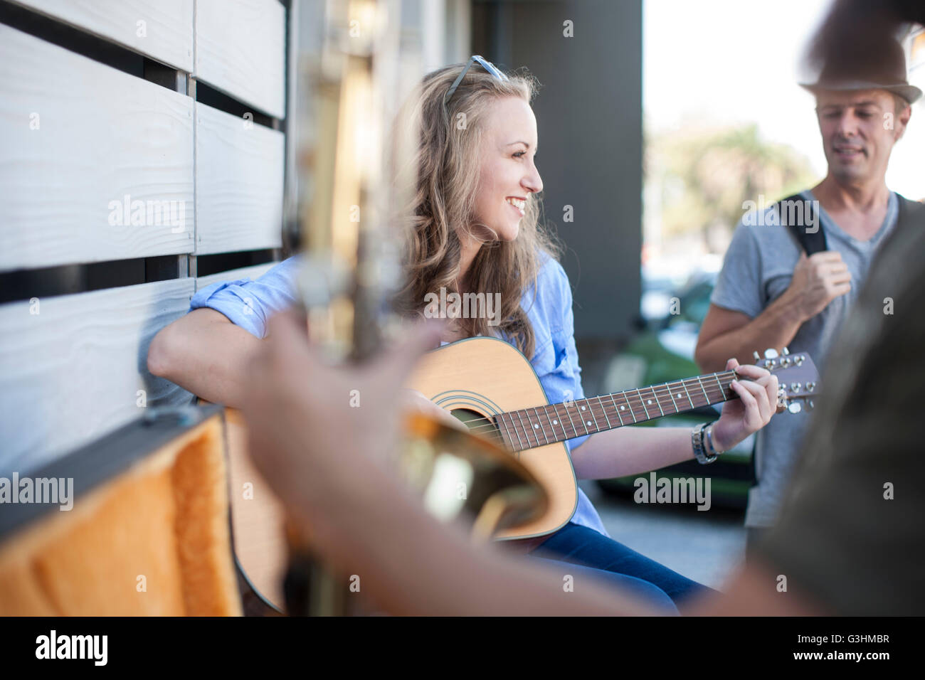 Female street musician, playing guitar Stock Photo - Alamy
