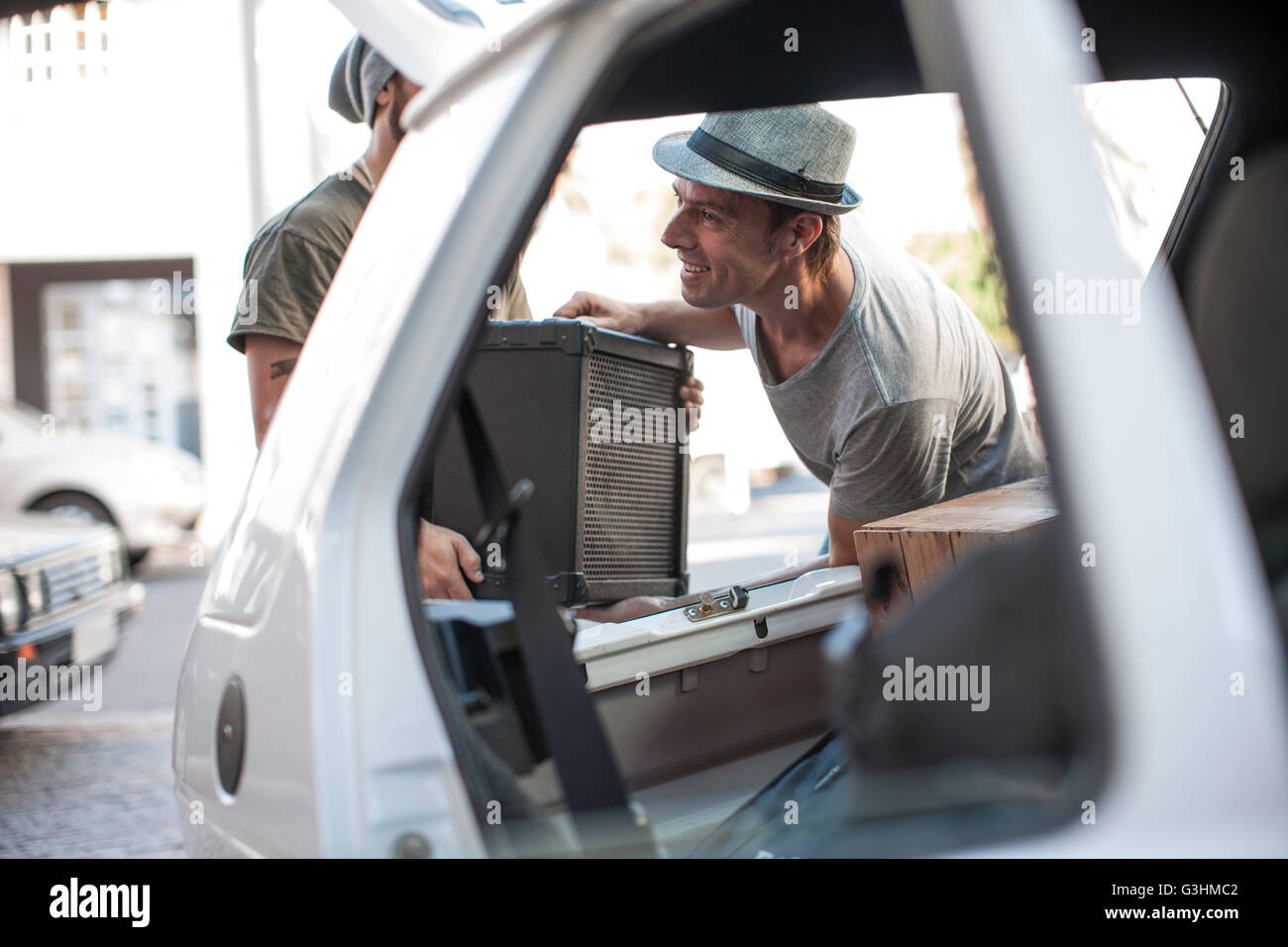 Musicians packing equipment into vehicle Stock Photo - Alamy