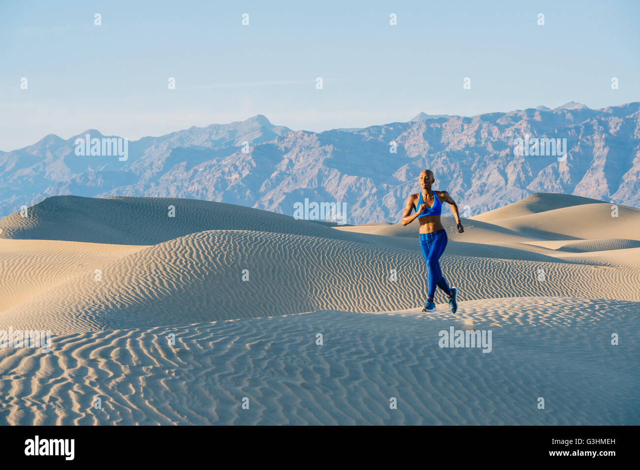 Runner sprinting in desert, Death Valley, California, USA Stock Photo ...
