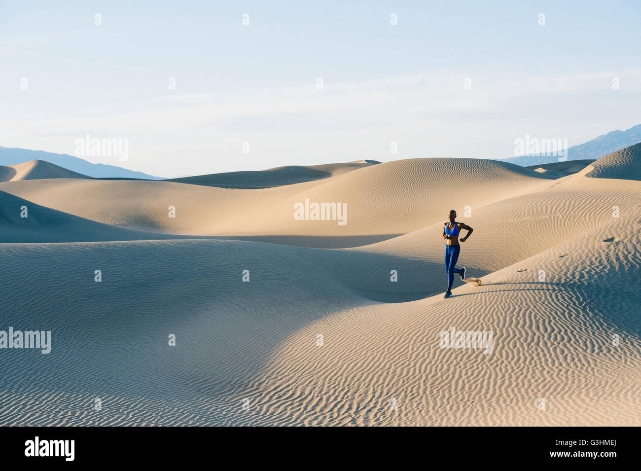 Runner sprinting in desert, Death Valley, California, USA Stock Photo ...