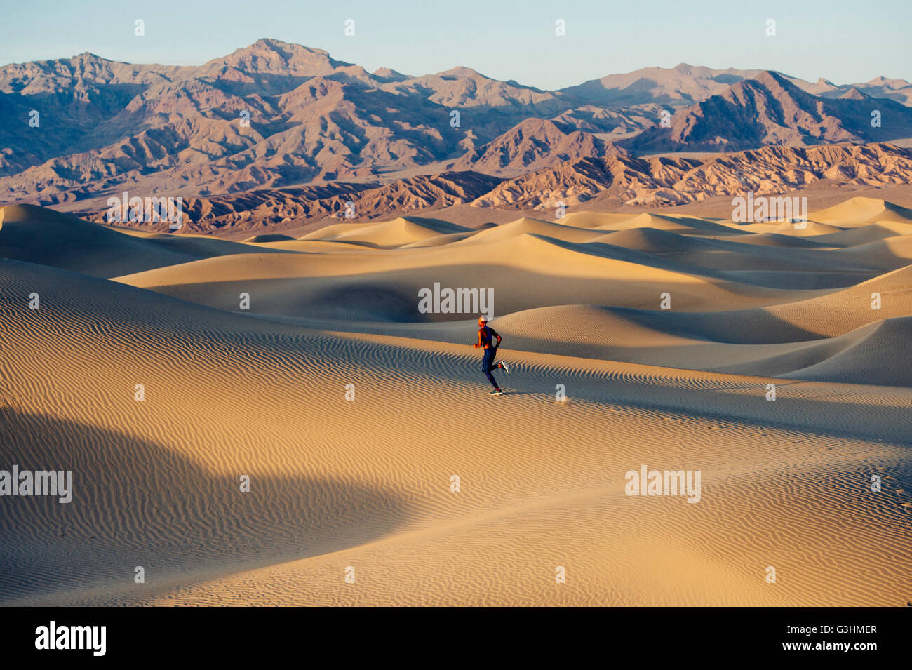 Runner sprinting in desert, Death Valley, California, USA Stock Photo ...