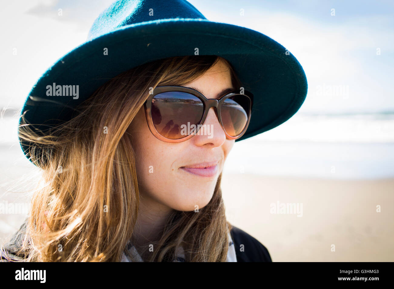 Portrait of stylish woman wearing felt hat and sunglasses, Dillon Beach ...