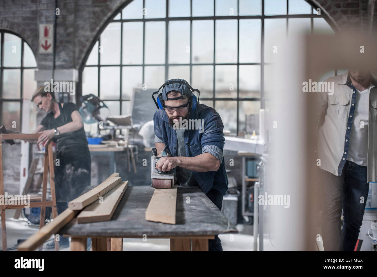 Carpenter sanding wood in antique restoration workshop Stock Photo - Alamy