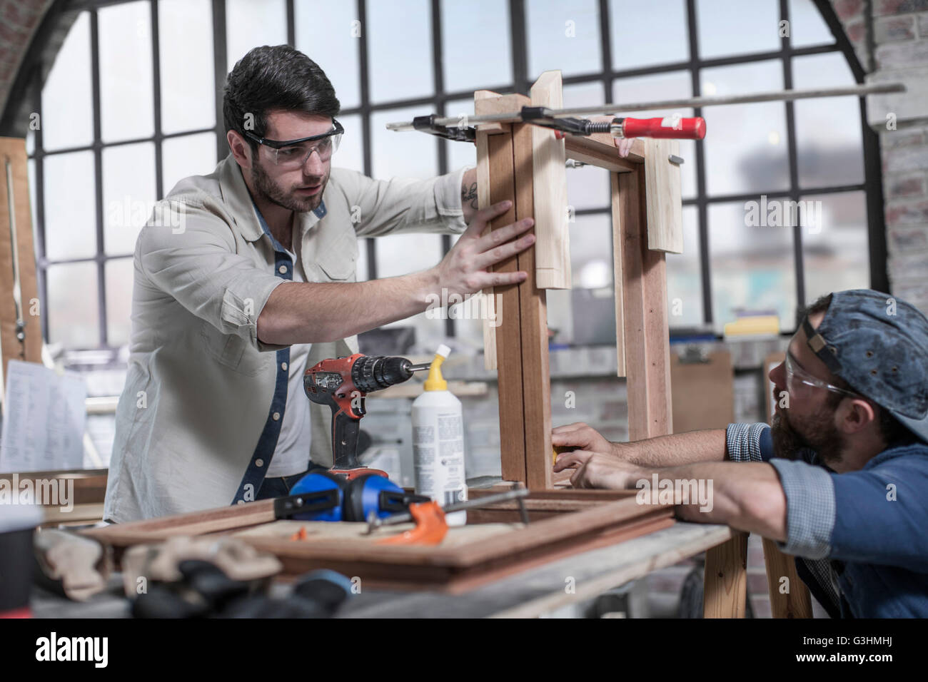 Carpenters inspecting framework in antique restoration workshop Stock ...