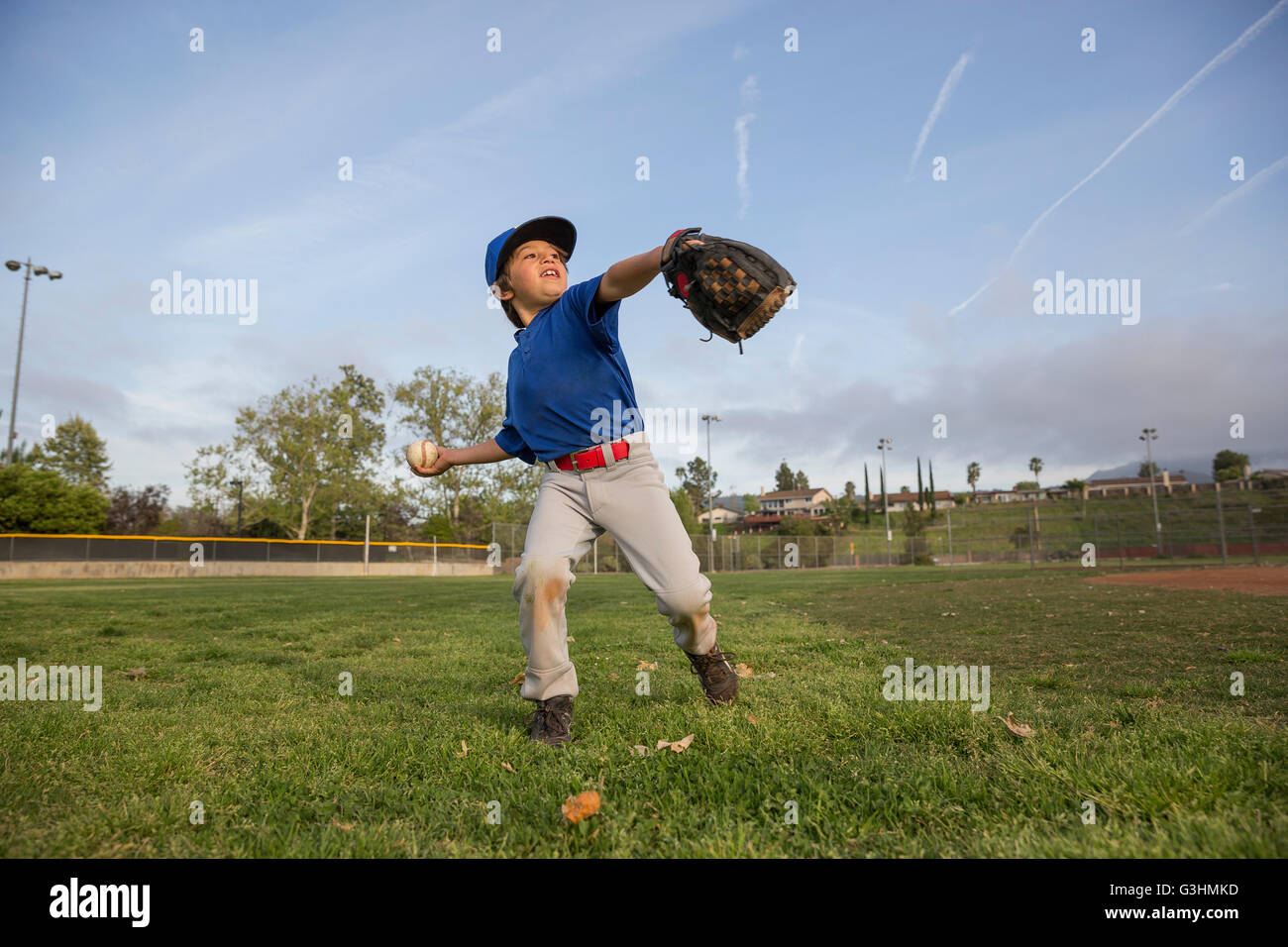 Boy throwing ball at practise on baseball field Stock Photo - Alamy