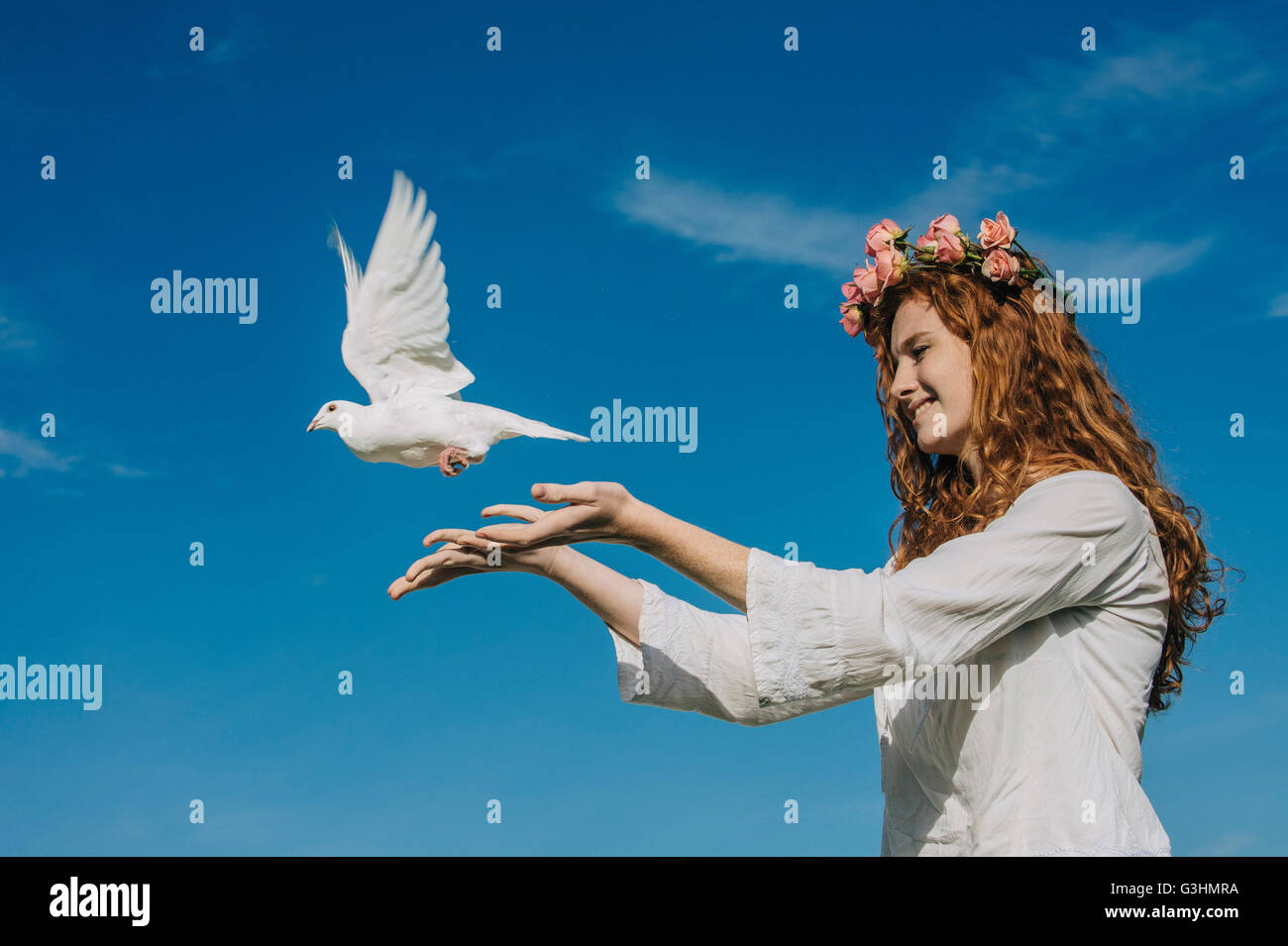 Teenage girl releasing white dove into sky Stock Photo - Alamy