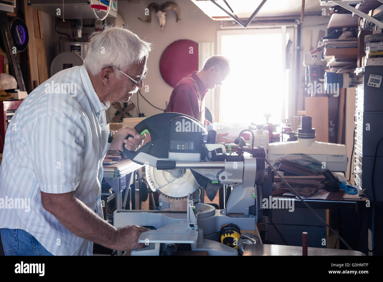 Senior man sawing on circular saw in carpentry workshop Stock Photo - Alamy