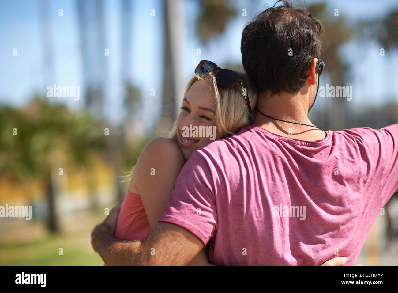 Couple outdoors, hugging, smiling, rear view Stock Photo - Alamy