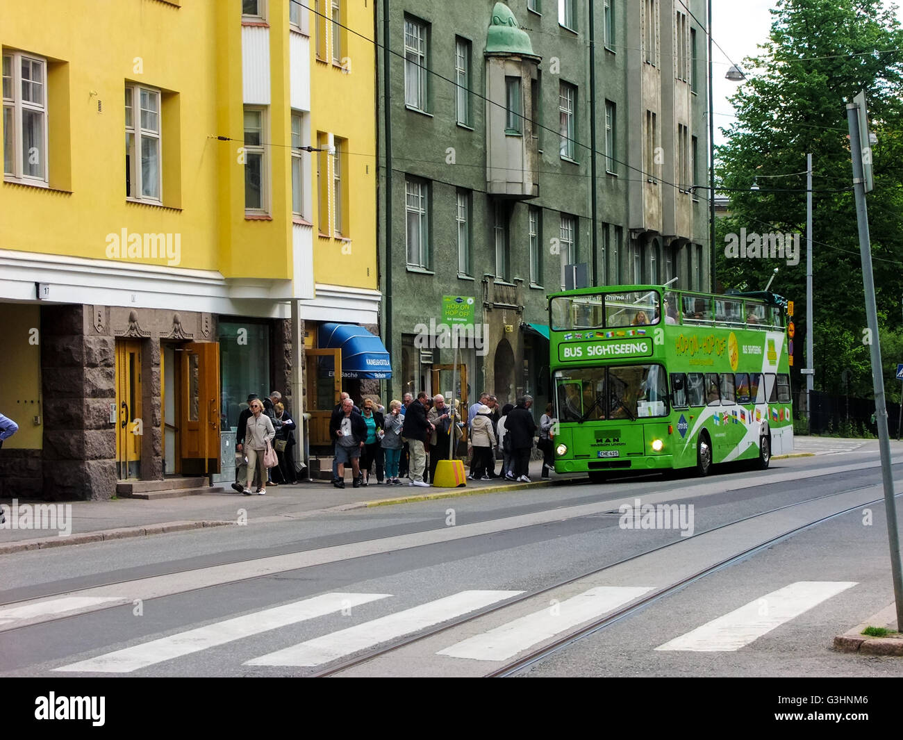 Tourists hopping on and off the sightseeing bus at Helsinki, Finland ...
