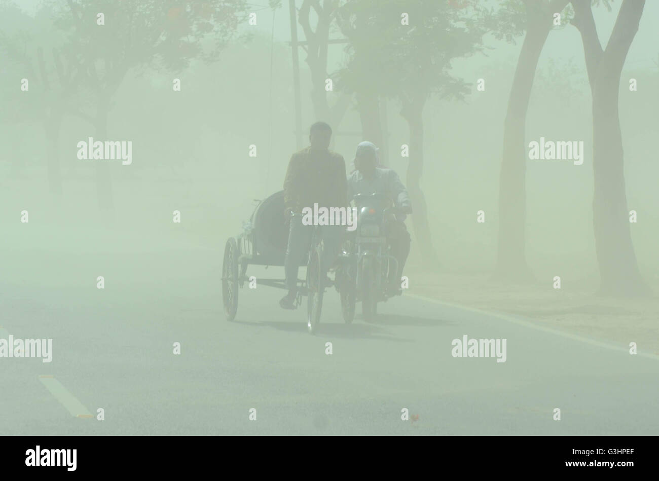 Allahabad, India. 21st Apr, 2016. People walks trough dust storm during ...