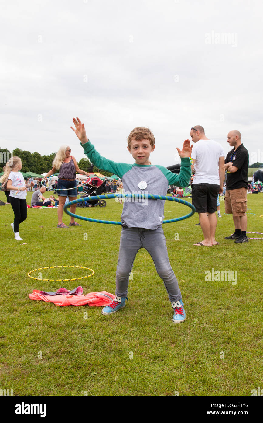Boy with a hula hoop at the Alresford music festival 2016, Hampshire ...