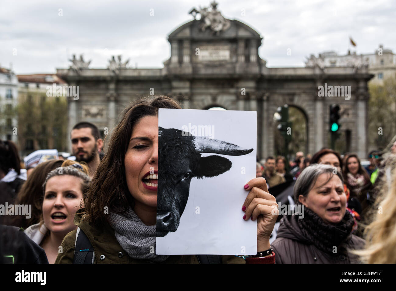 A woman with an image of a bull protesting against animal torture and ...