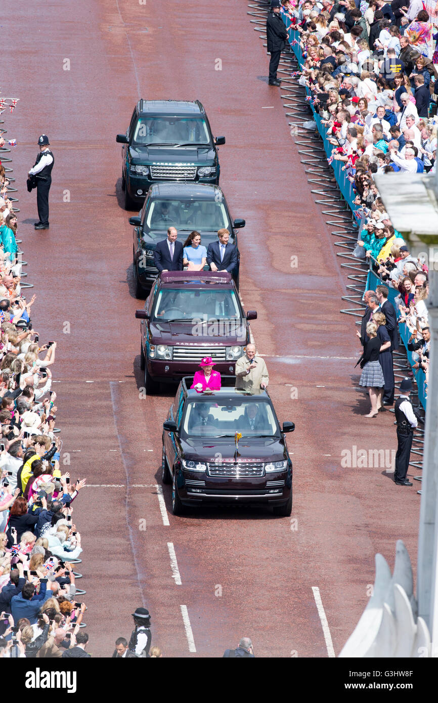 Queen Elizabeth II and the Duke of Edinburgh lead a convoy of cars ...