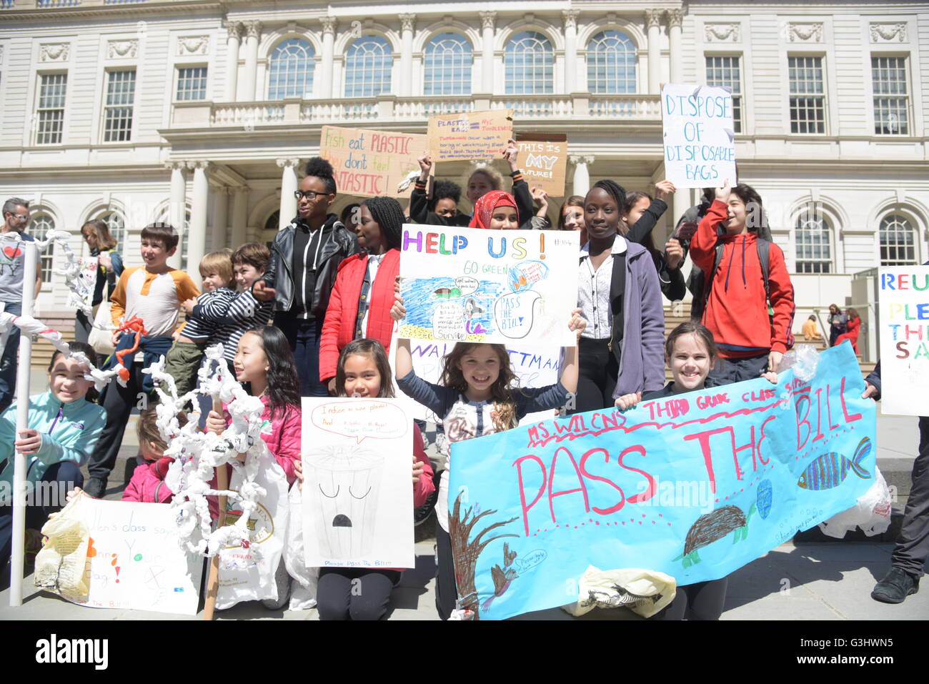Students from MS 246 & the Hewitt School hold hand-made signs & banners ...