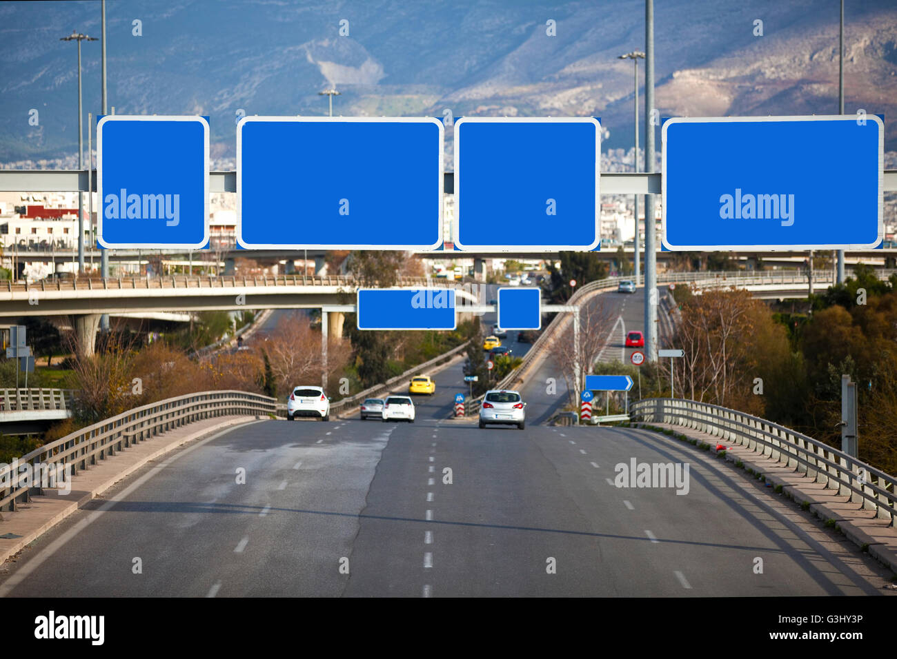 Cars on highway with blank directional road signs Stock Photo - Alamy