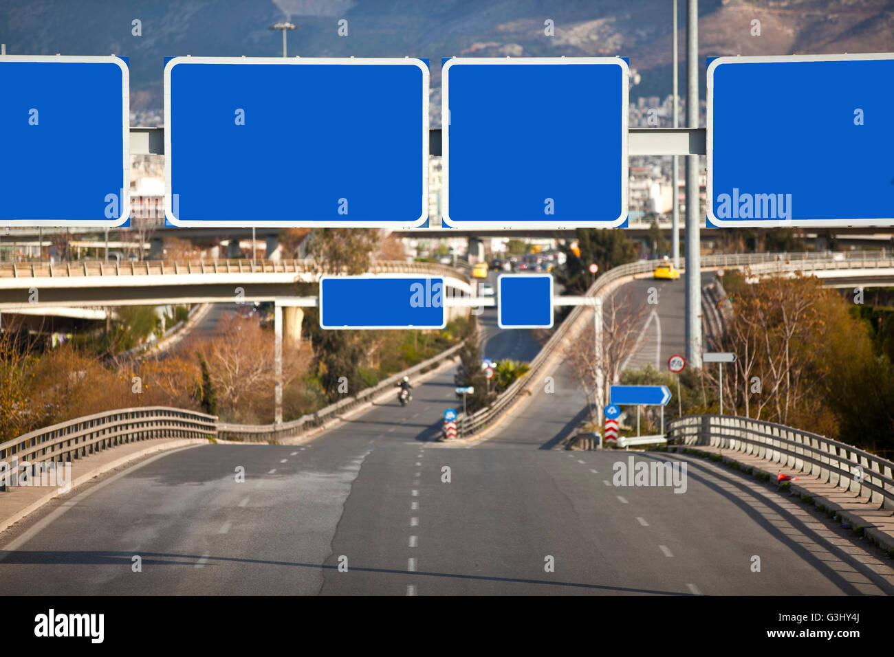 Cars on highway with blank directional road signs Stock Photo - Alamy