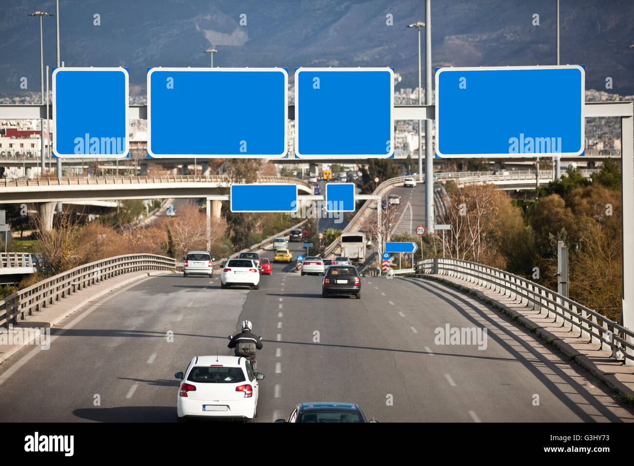 Cars on highway with blank directional road signs Stock Photo - Alamy
