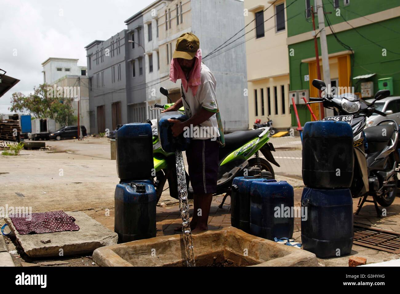 A man fills a clean water to a housing complex at a coastal area ...