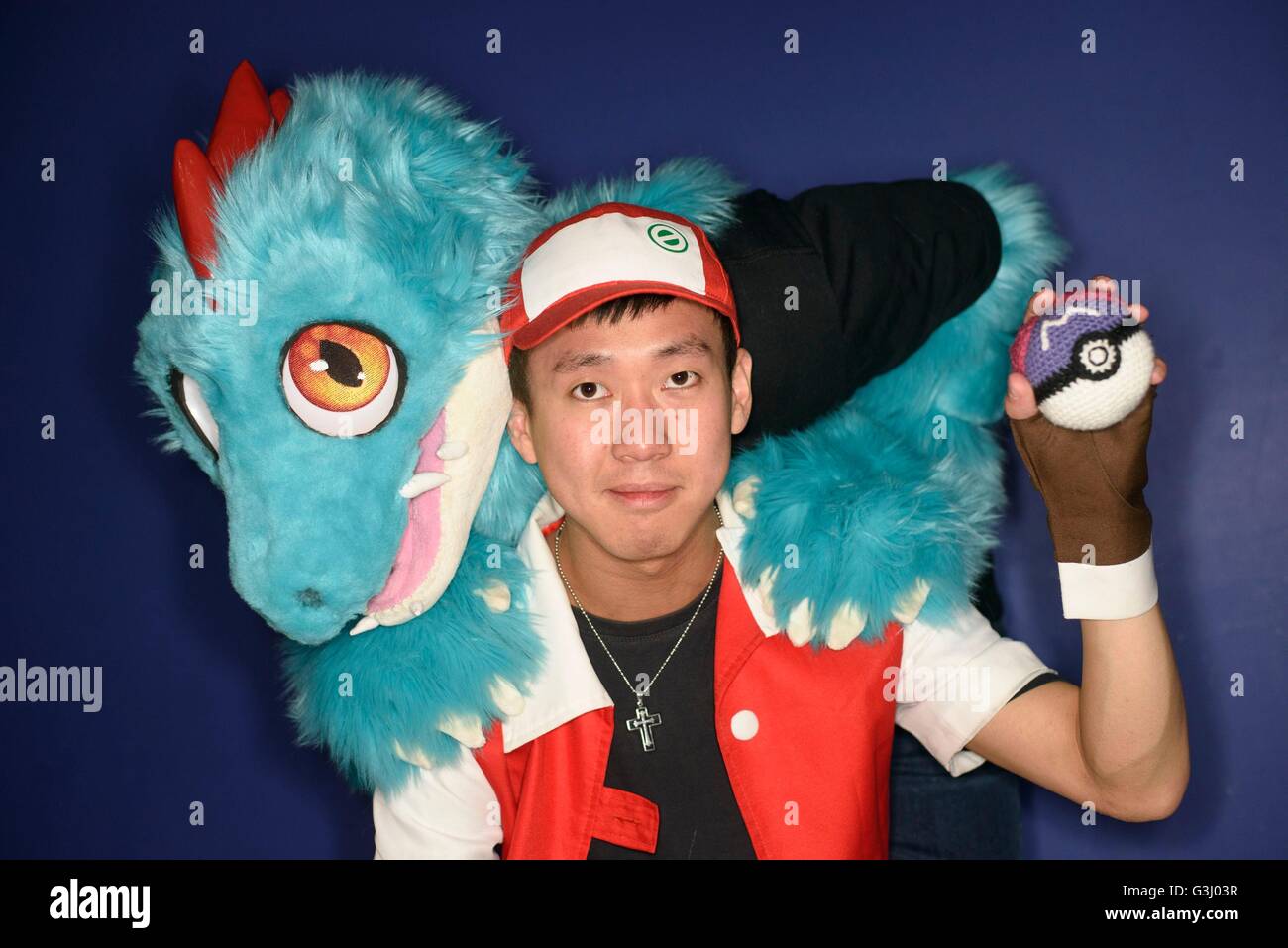 Cosplayers Henry Woo, 26 (front) dressed as Trainer Red and James ...