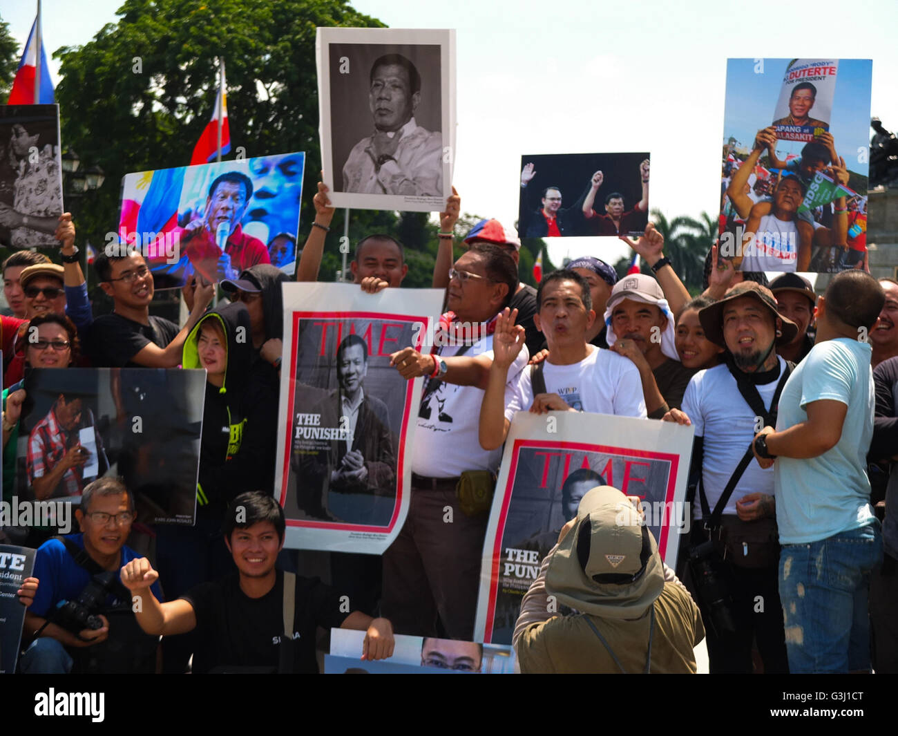 Photographers holding their pictures of President-elect Rodrigo Duterte ...