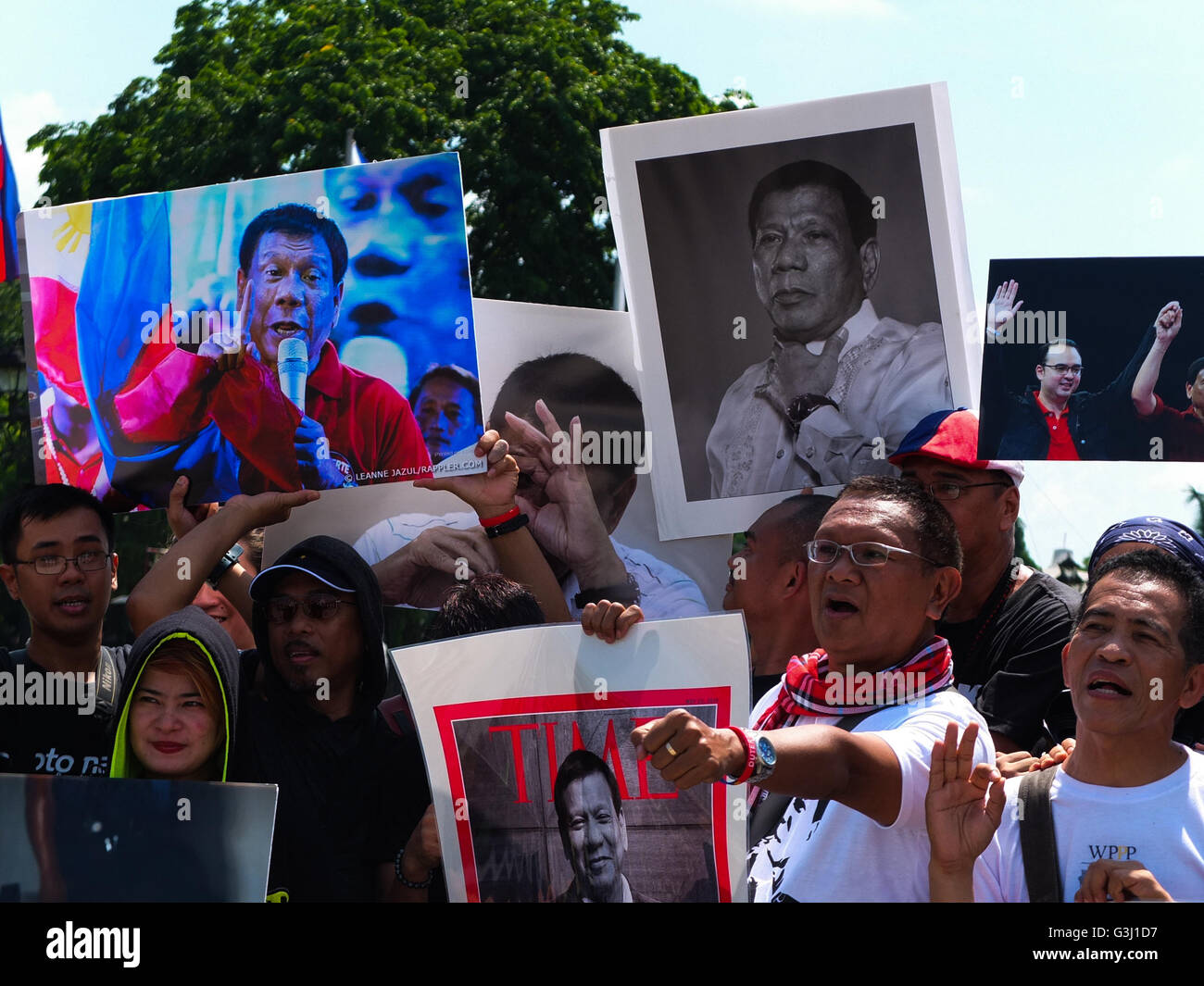 Photographers holding their pictures of President-elect Rodrigo Duterte ...
