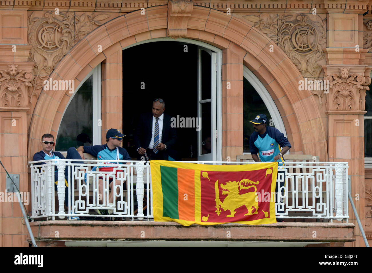A member of MCC staff looks-on as Sri Lanka staff hang a Sri Lankan ...