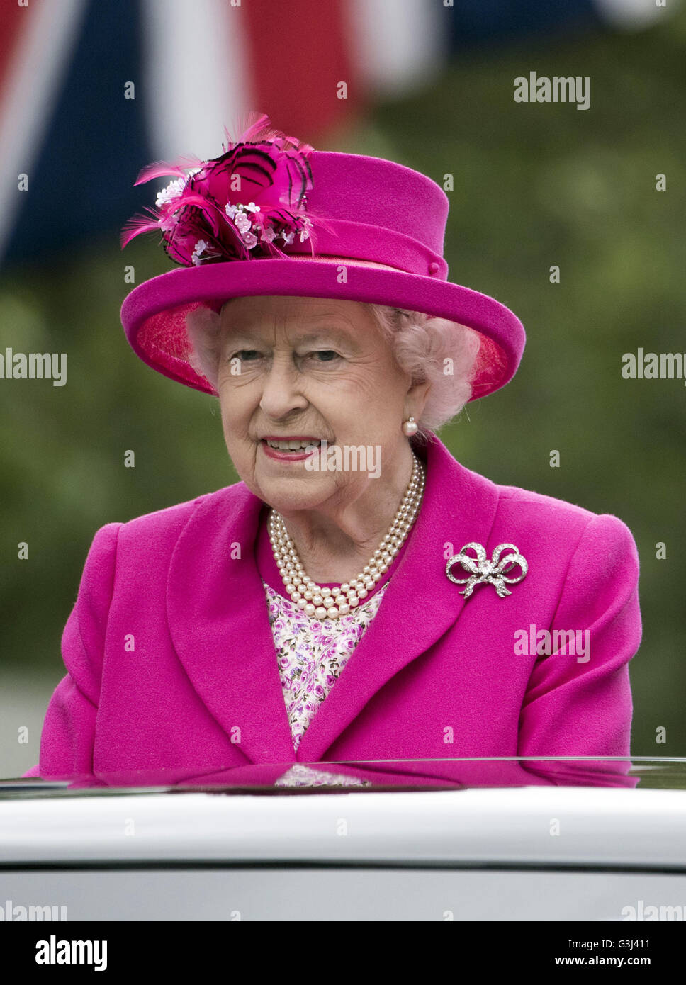 Queen Elizabeth II makes her way down The Mall in an open topped Range ...
