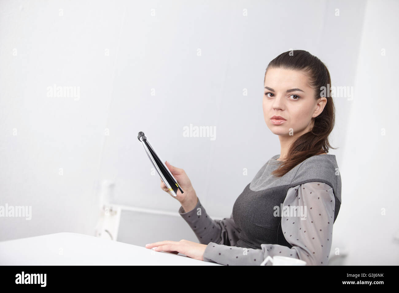 Business lady with a notepad in the office Stock Photo - Alamy