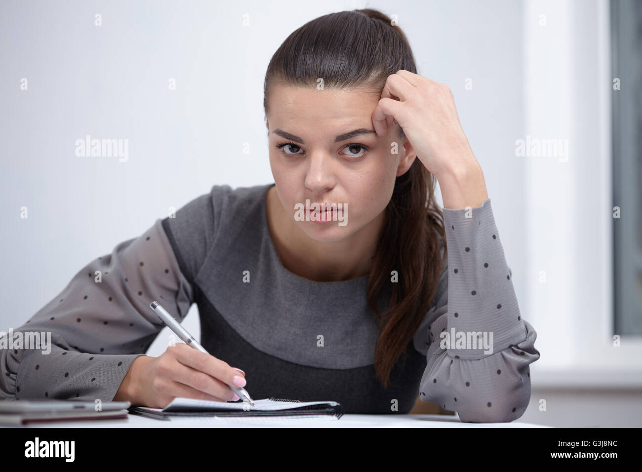 business woman writing in a notepad in the office Stock Photo - Alamy