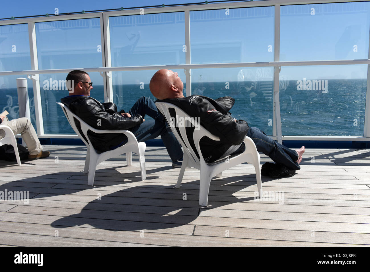 Passengers sitting on deck of MV Pont-Aven the Brittany Ferries ...