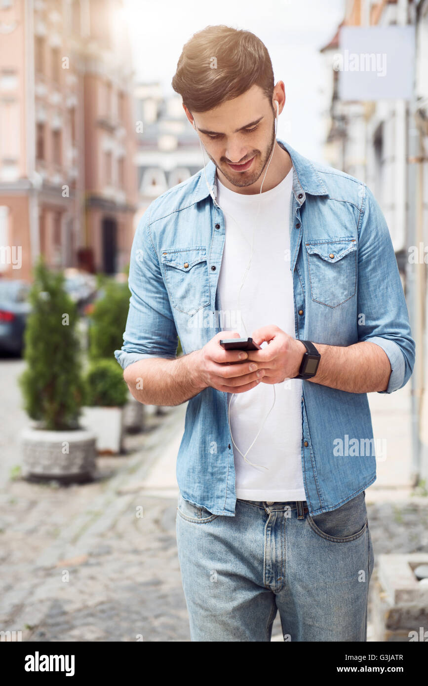 Pleasant handsome man standing in the street Stock Photo - Alamy