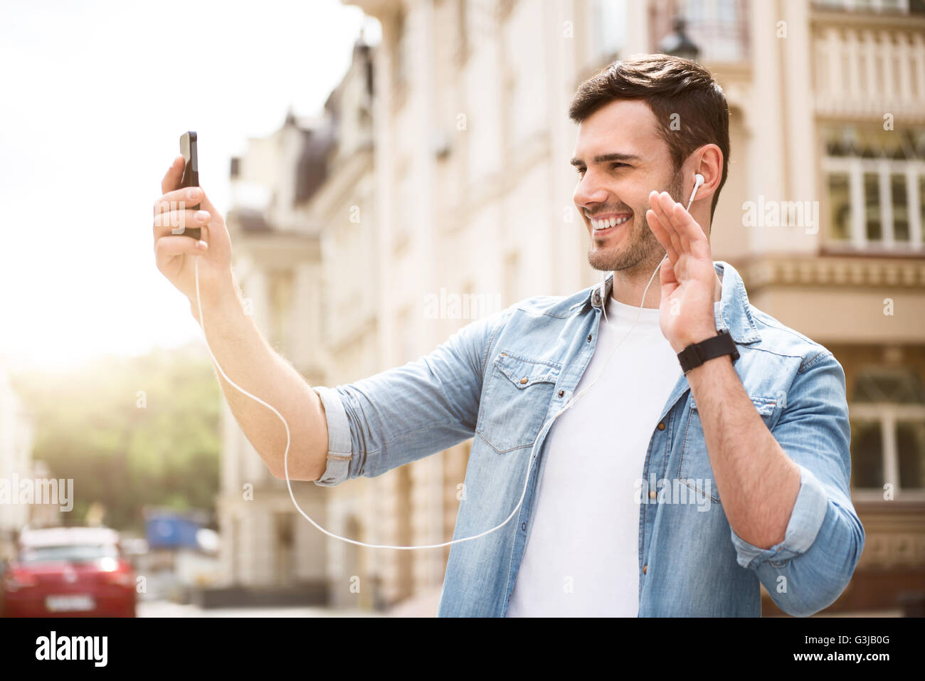 Positive man holding cell phone Stock Photo - Alamy