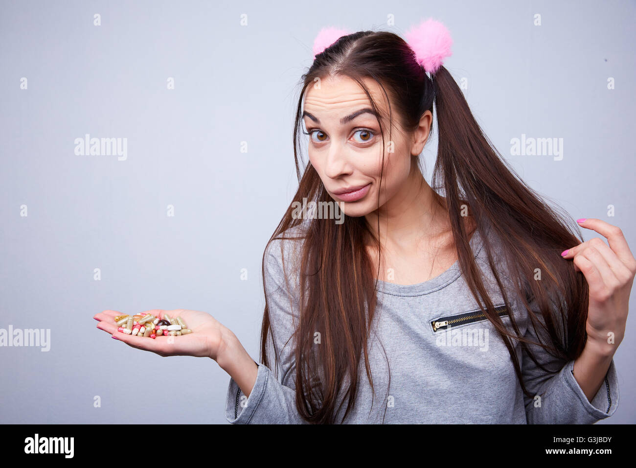 fun girl drinks a lot of pills Stock Photo - Alamy
