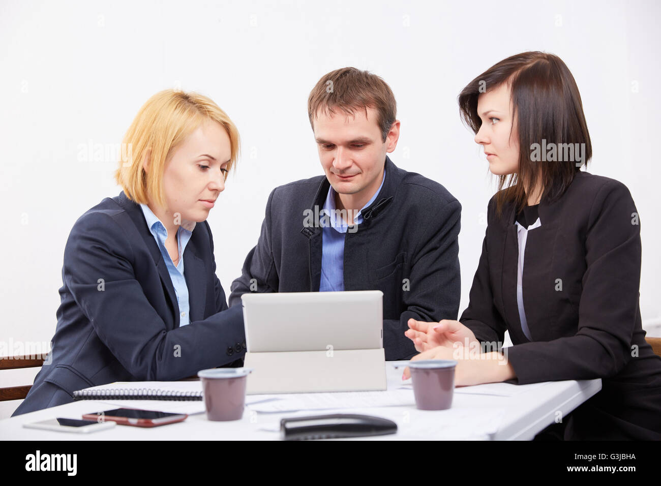 Three businessmen at a meeting Stock Photo - Alamy