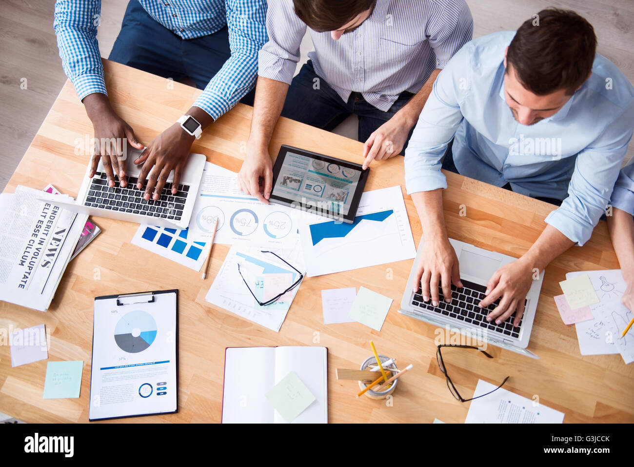 Busy colleagues sitting at the table Stock Photo - Alamy