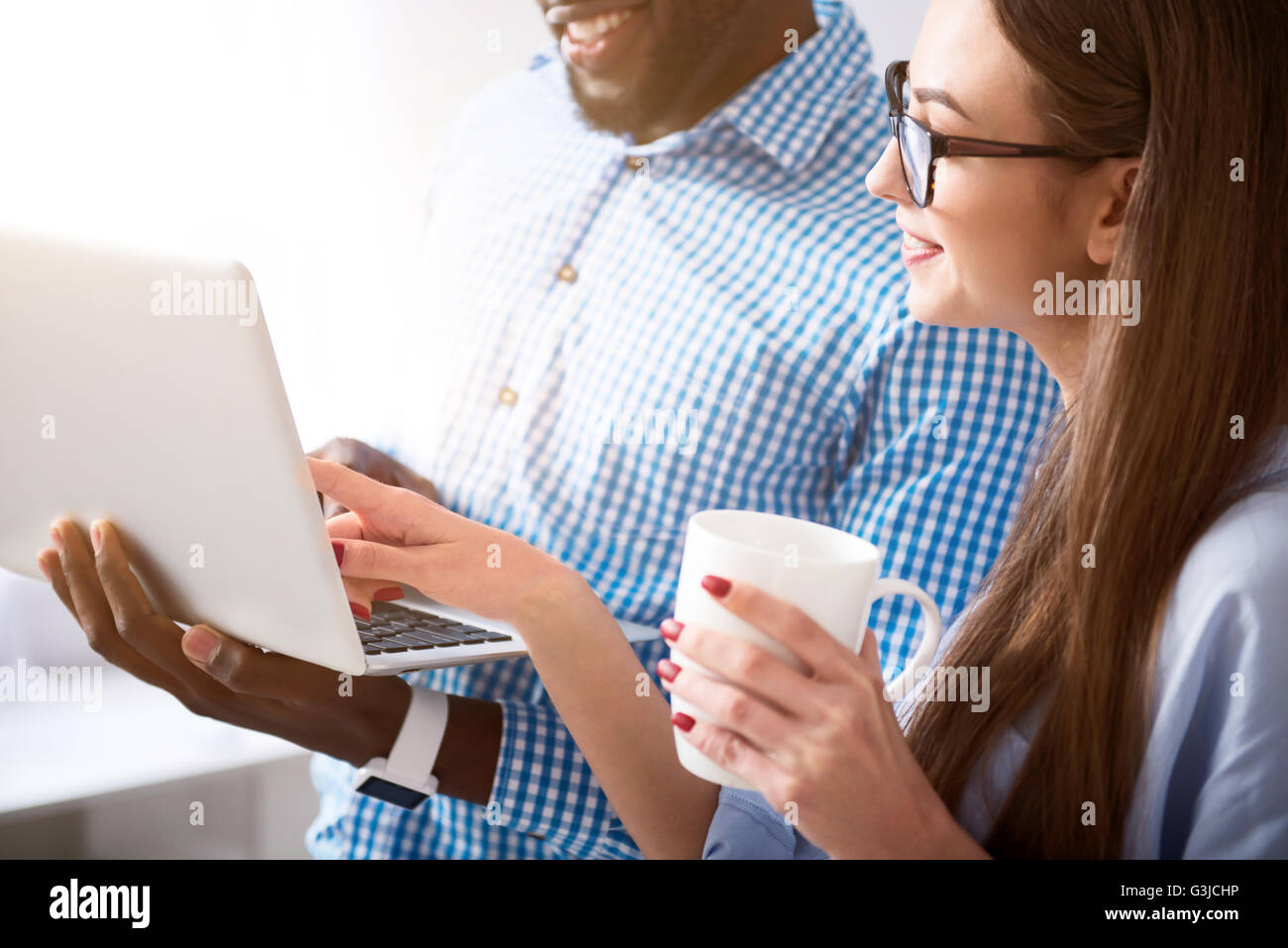 Pleasant smiling colleagues talking Stock Photo - Alamy