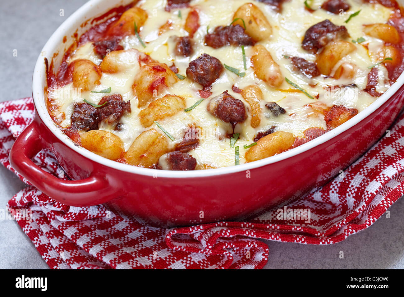 Potato gnocchi with italian sausage and tomato sauce Stock Photo - Alamy