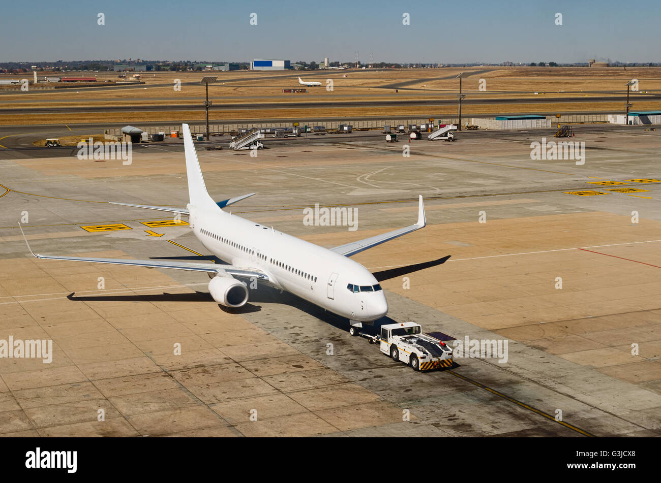 Airplane being pushback or towed by a special tractor Stock Photo - Alamy