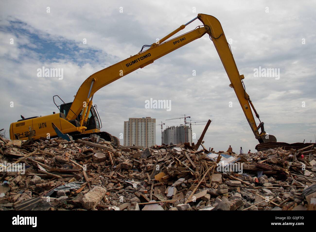 Officials use a bulldozer to demolish illegal houses during an eviction ...