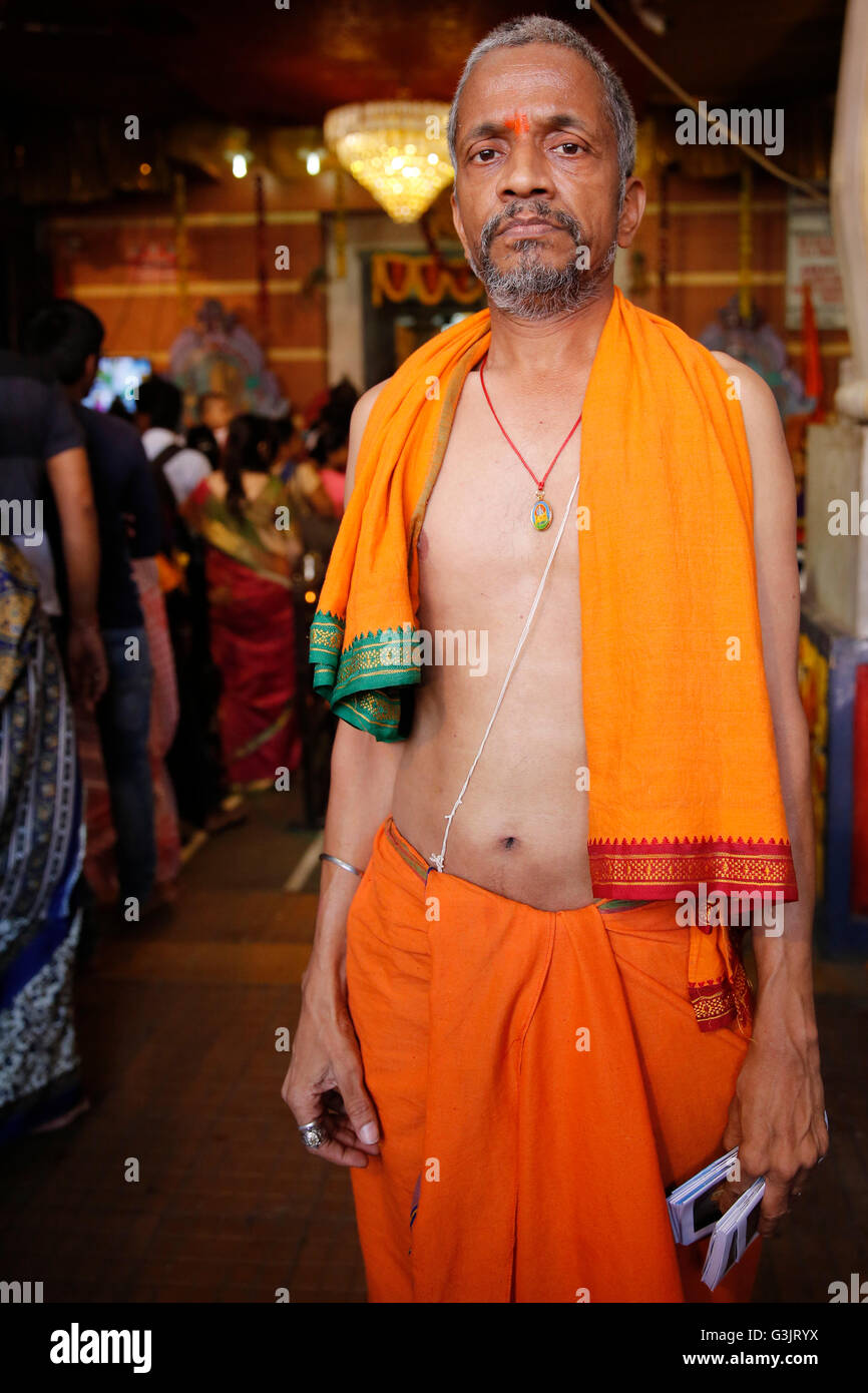 Mumbai, India. 16th Apr, 2016. A priest poses for a picture outside a ...