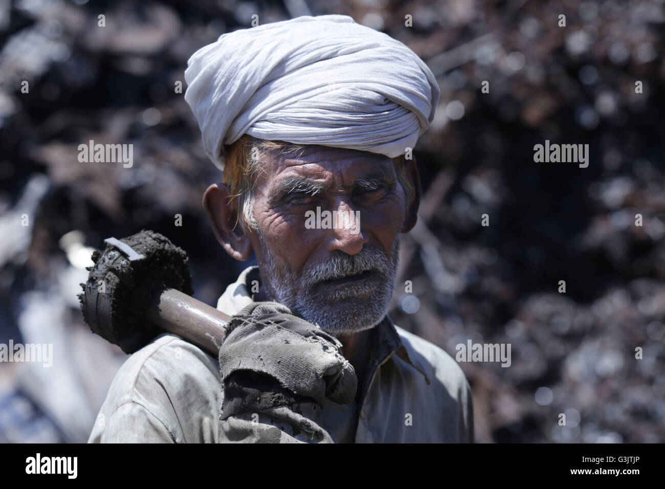 Pakistani blacksmiths work at an iron molding factory in an industrial ...