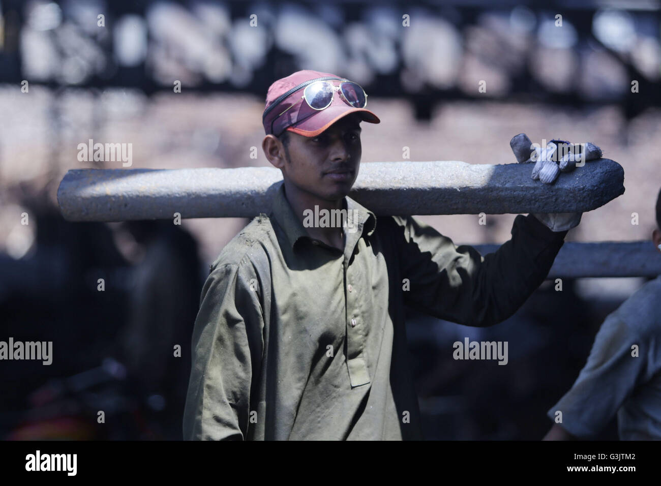 Pakistani blacksmiths work at an iron molding factory in an industrial ...