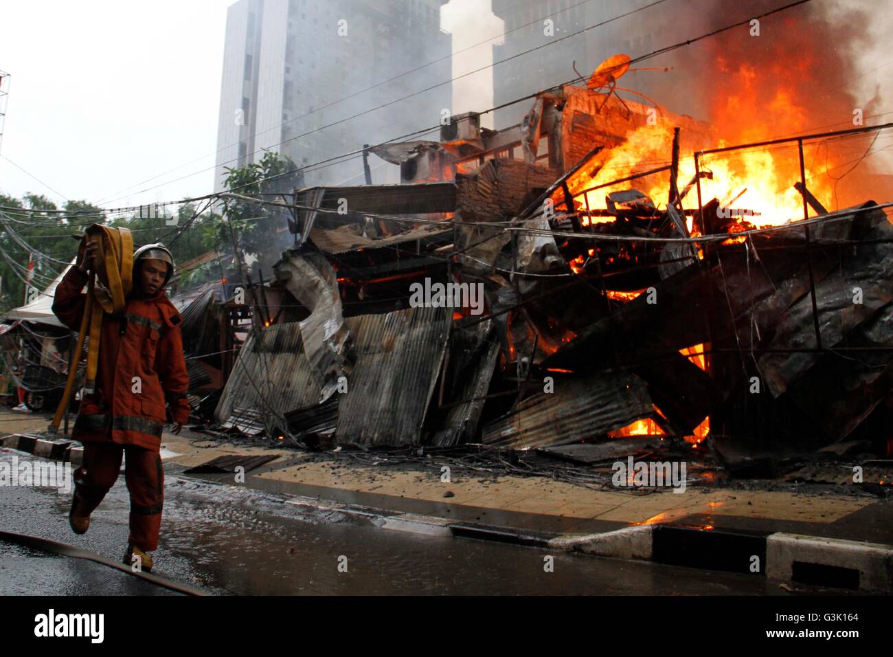 Jakarta, Indonesia. 17th Apr, 2016. A firefighter walks through the ...