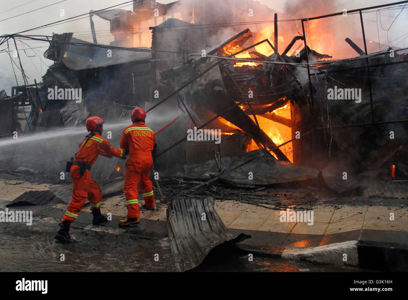 Jakarta, Indonesia. 17th Apr, 2016. Firefighter uses a fire hose to put ...