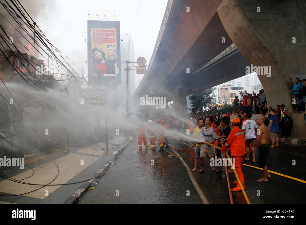 Jakarta, Indonesia. 17th Apr, 2016. Firefighter uses a fire hose to put ...
